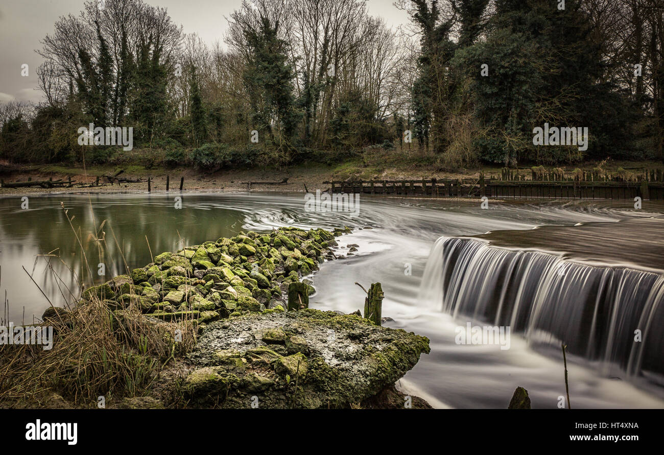 Water flowing through the lock gate system and waterfall at Beeleigh ...