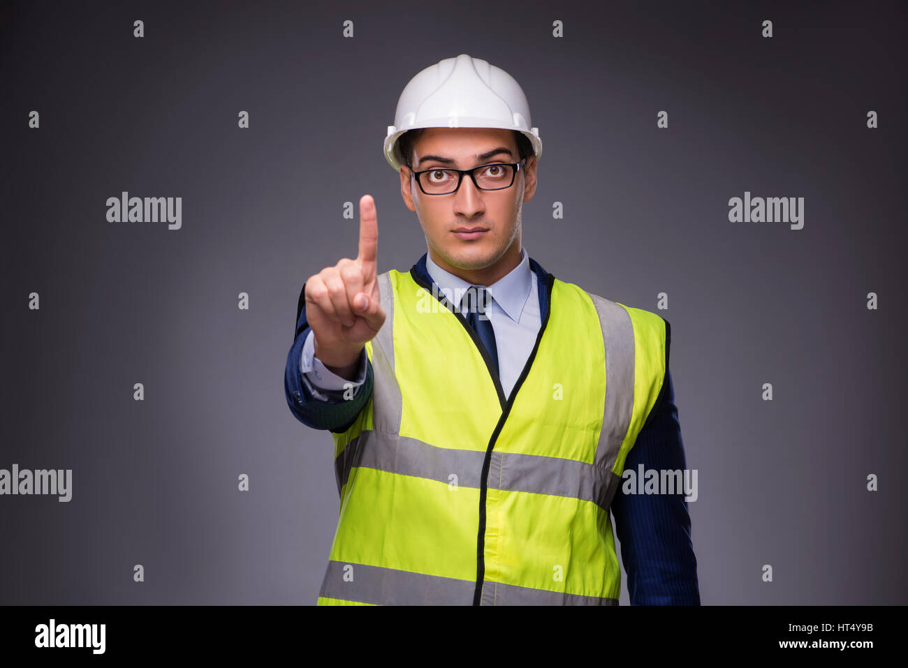 Man wearing hard hat and construction vest Stock Photo - Alamy