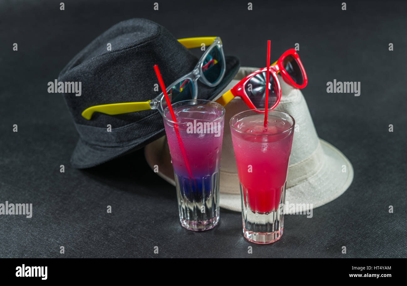 Two colored drinks, a combination of dark blue with purple, the second ...