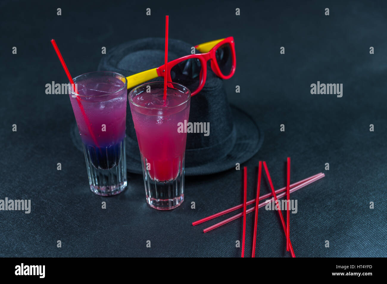 Two colored drinks, a combination of dark blue with purple, the second ...