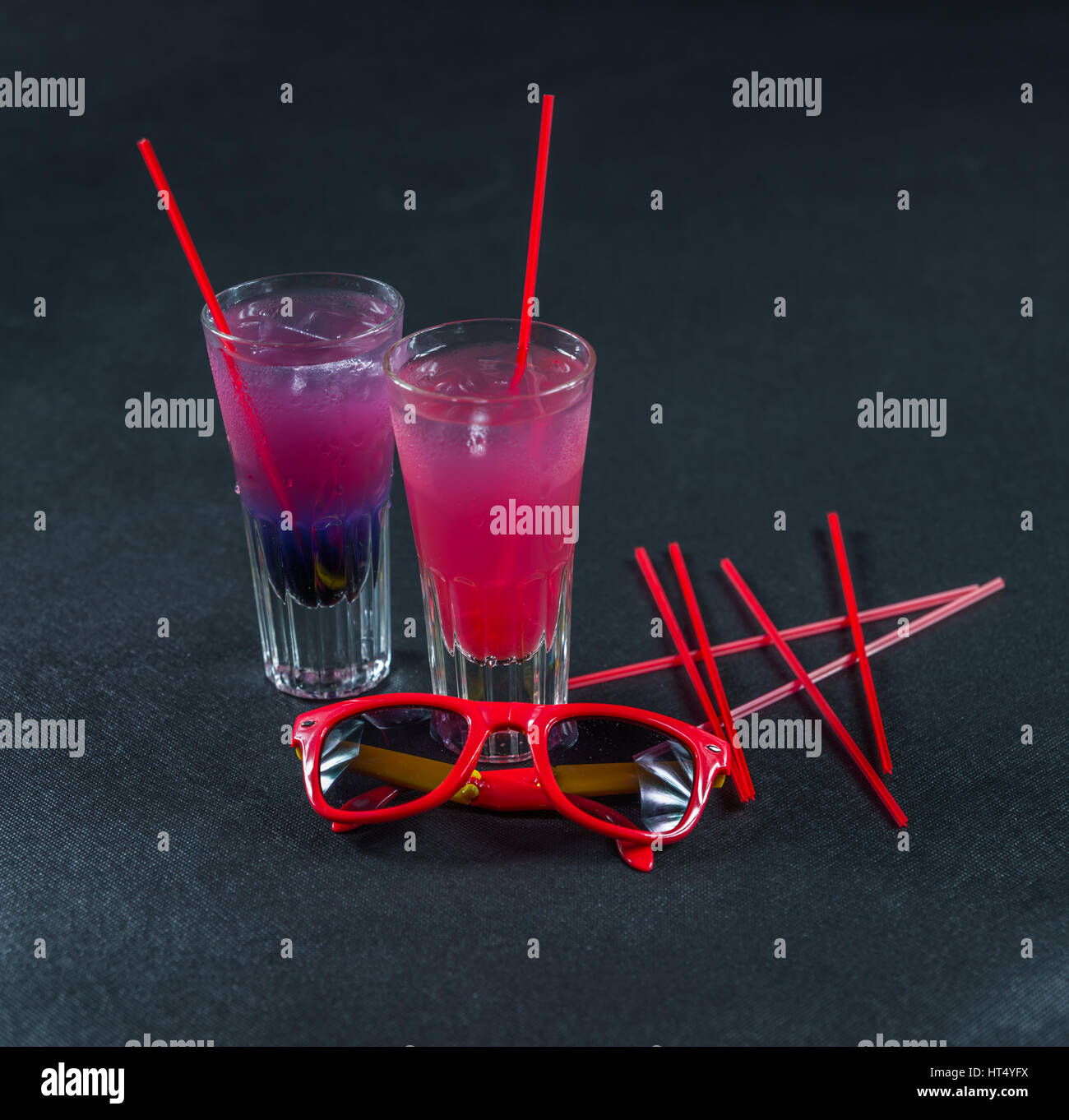Two colored drinks, a combination of dark blue with purple, the second ...