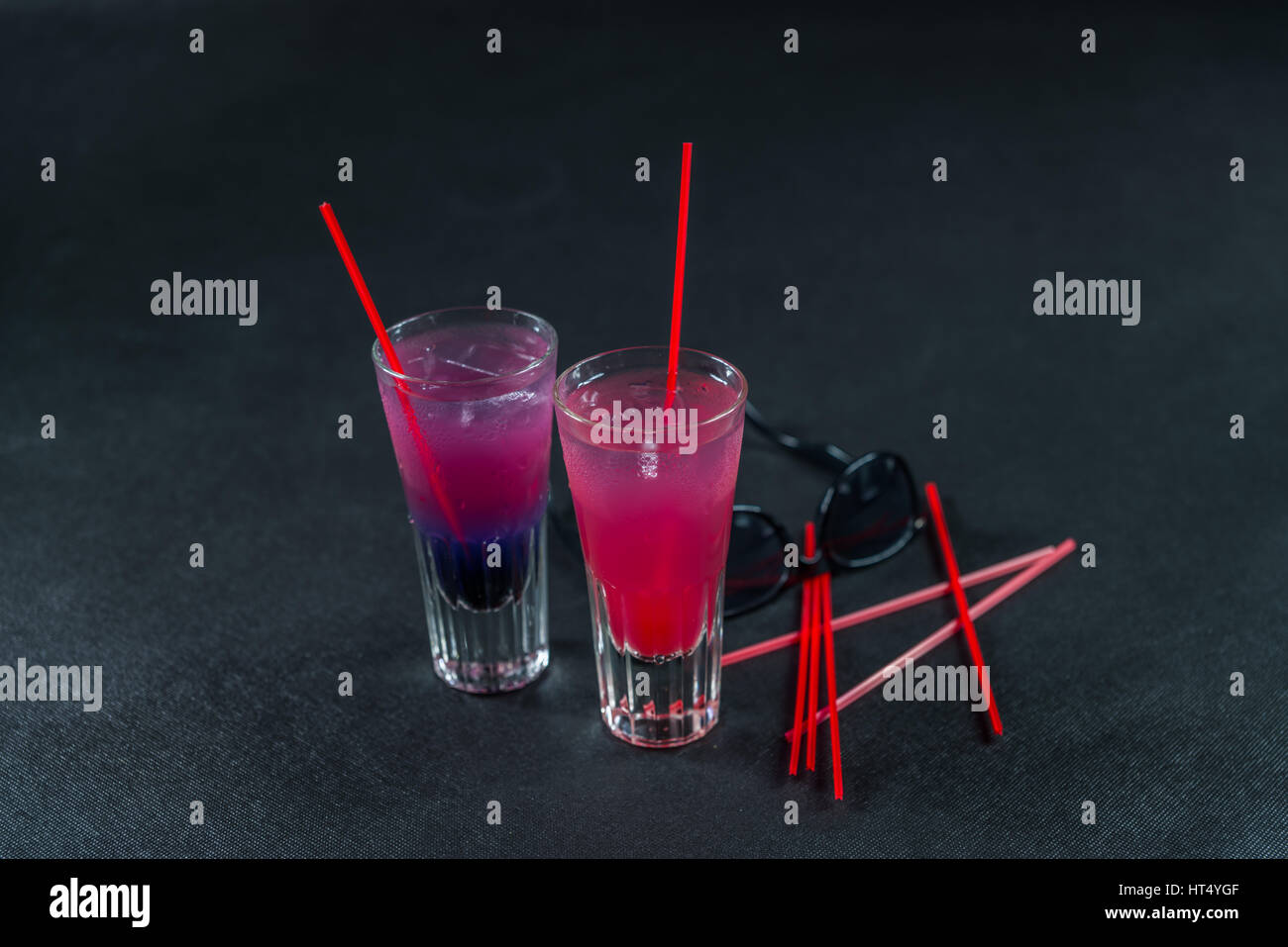 Two colored drinks, a combination of dark blue with purple, the second ...
