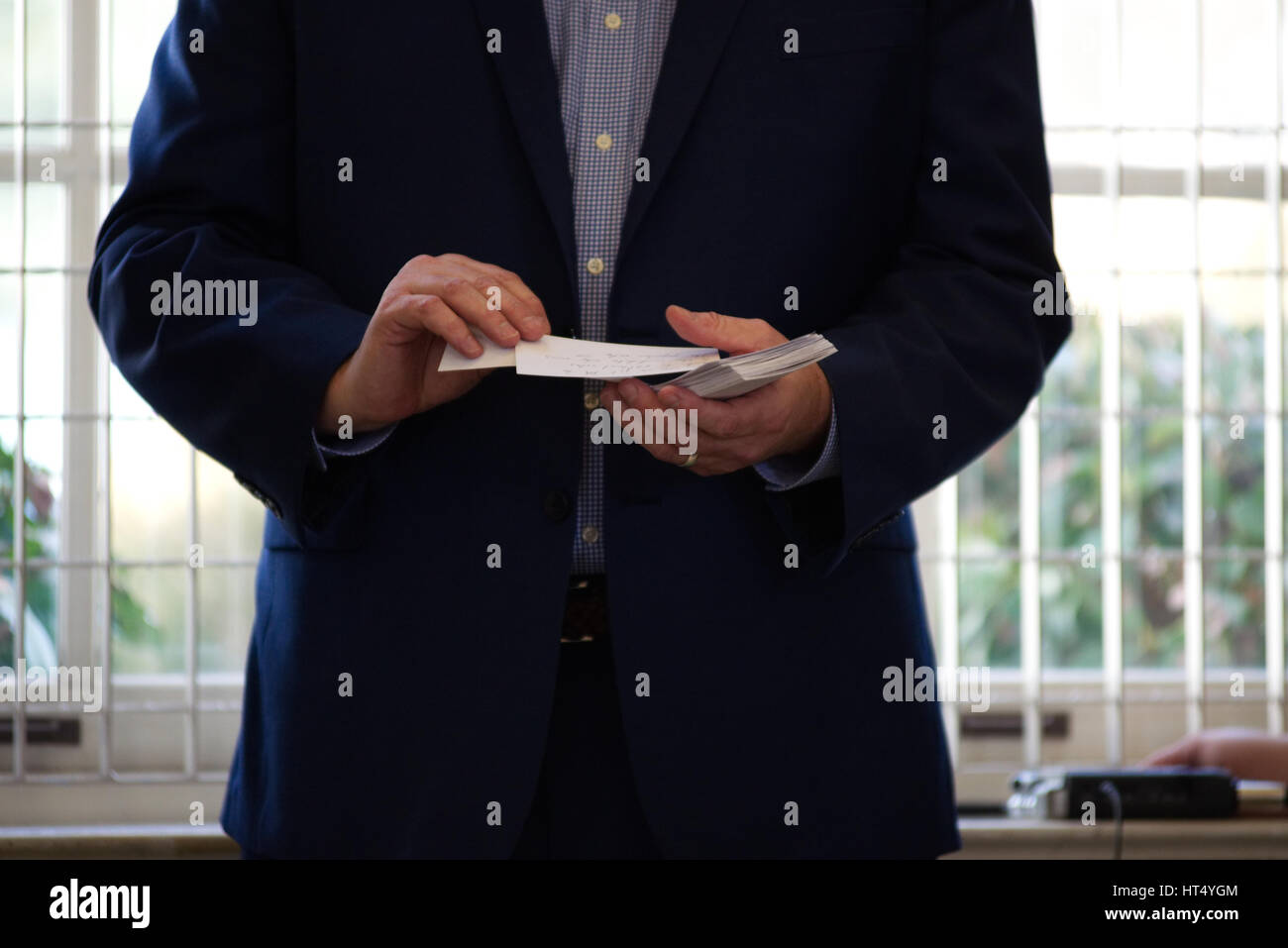 Community members listen as an elected representative reacts to ...