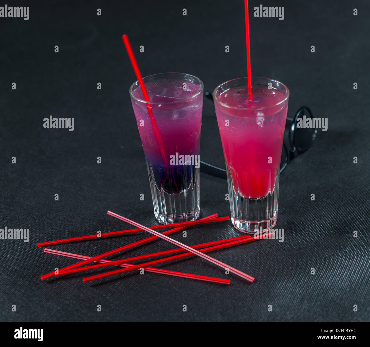 Two colored drinks, a combination of dark blue with purple, the second ...