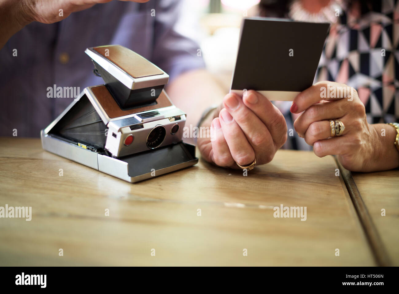 Close up couple checking instant camera image Stock Photo - Alamy