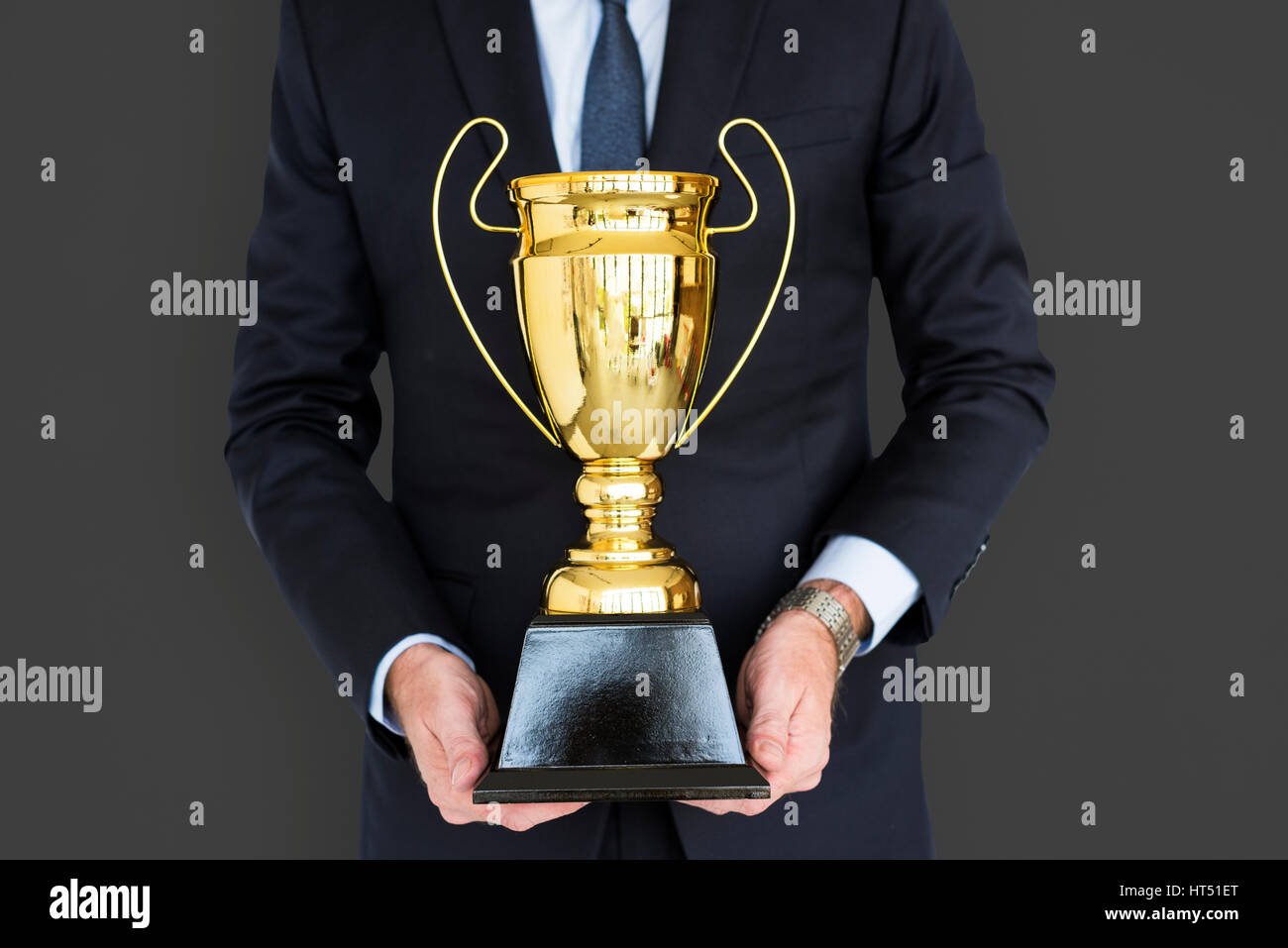 Business Man Holding Trophy Stock Photo - Alamy