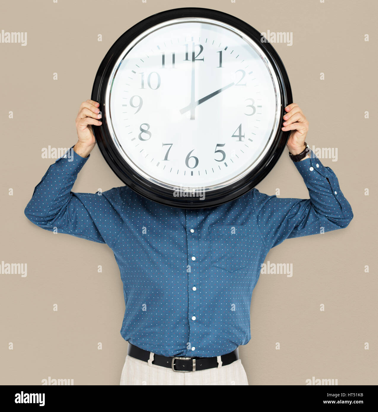 Man Holding Clock Covering Face Stock Photo - Alamy