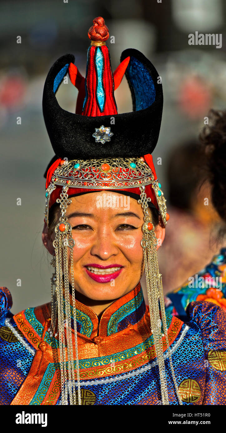 Young woman in traditional Deel clothes and hat with the typical ...