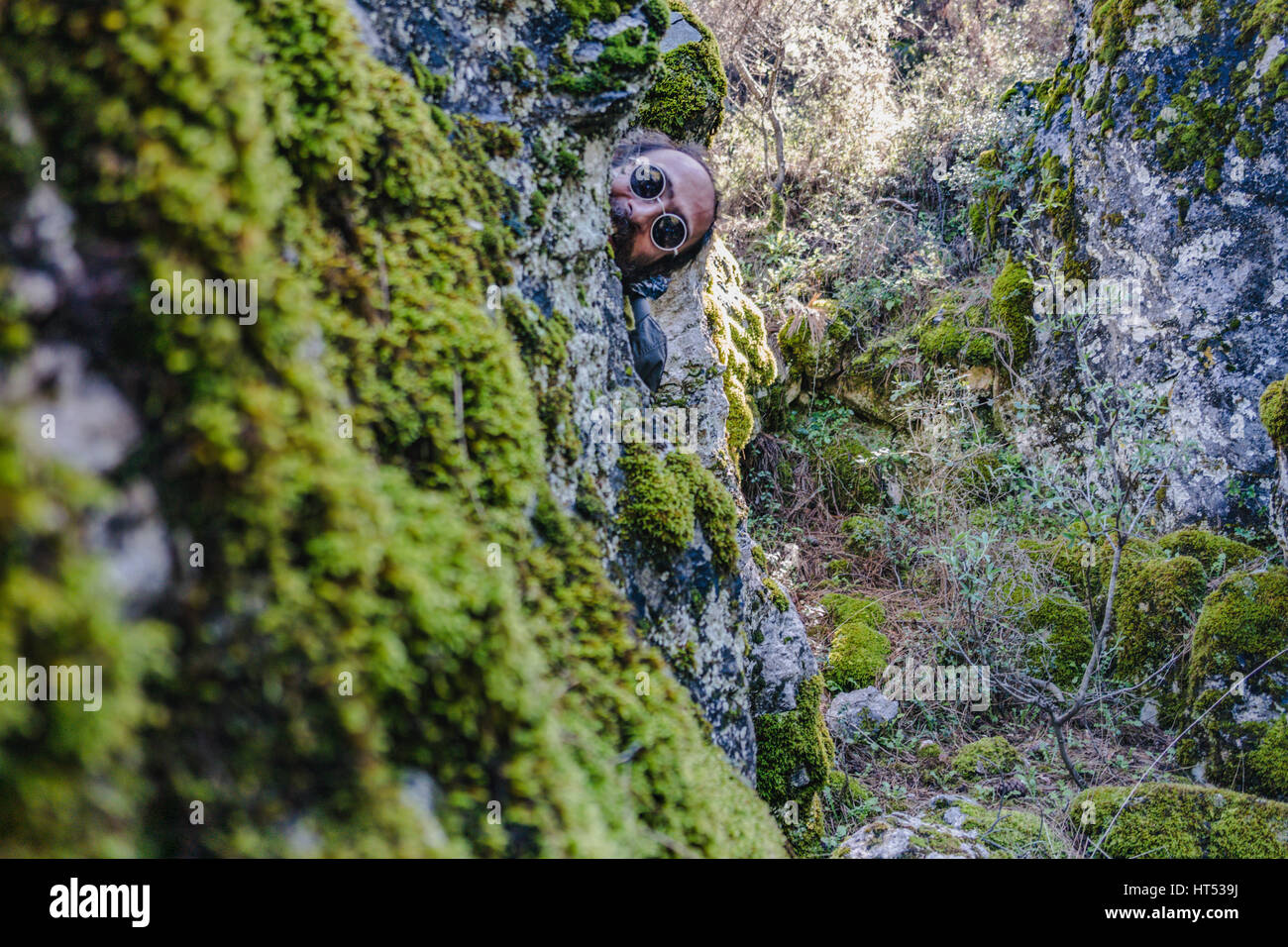 man showing his head in rock slit. head between the rocks Stock Photo ...