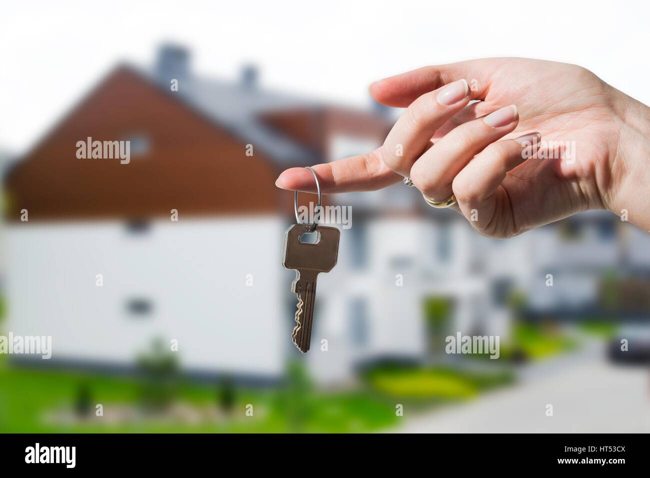 Woman's hand holding keys to new house Stock Photo - Alamy