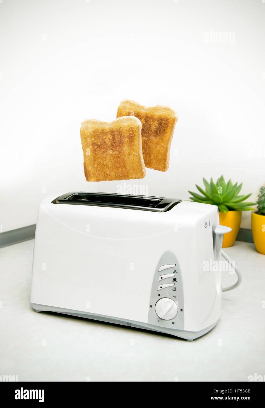 Jumping toasts. Prepare breakfast in kitchen Stock Photo - Alamy