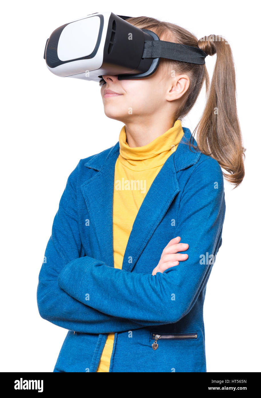 Happy little girl wearing virtual reality goggles watching movies or ...