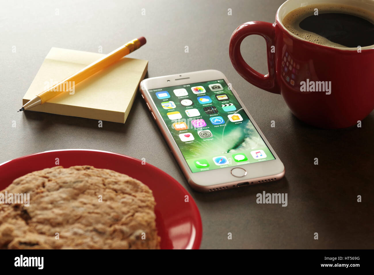 Koszalin, Poland – March 07, 2017: Pink iPhone 7 on stone table. Coffee ...