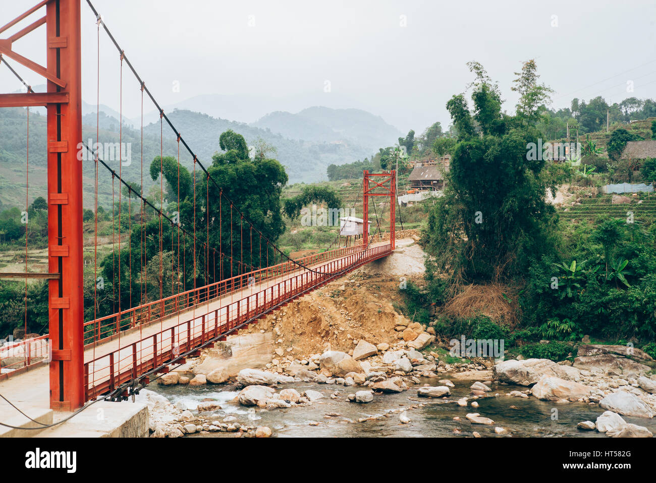 Red bridge crossing a river in the mountain of Sapa, north of Vietnam ...