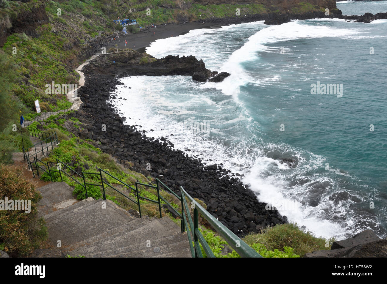 Winding path down to a beach with black lava sand and cliffs, picture ...