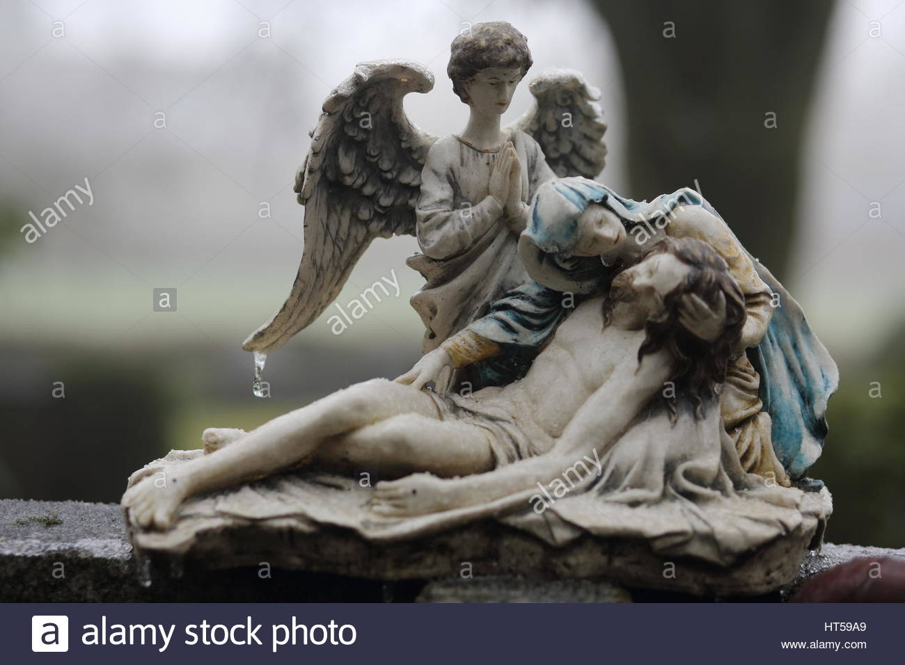 Mary attends the body of Jesus as an angel watches from above Stock ...