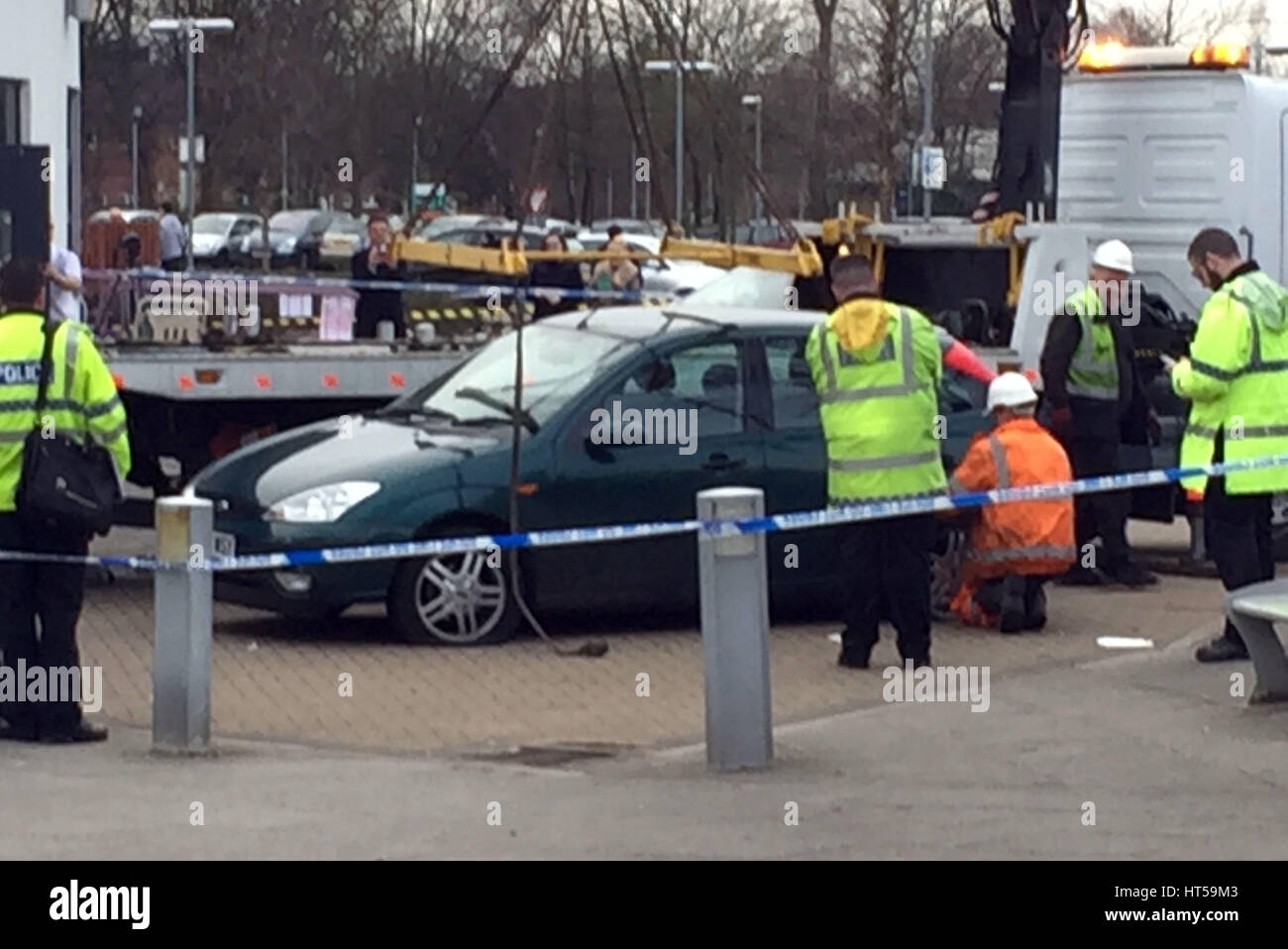 Police at the scene in a car park at Withington Community Hospital in ...