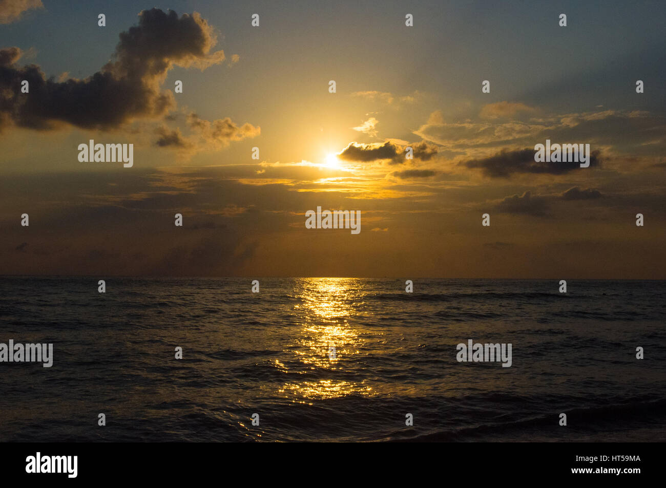 solar path on the sea on a Sunset and yellow sky with clouds Stock ...