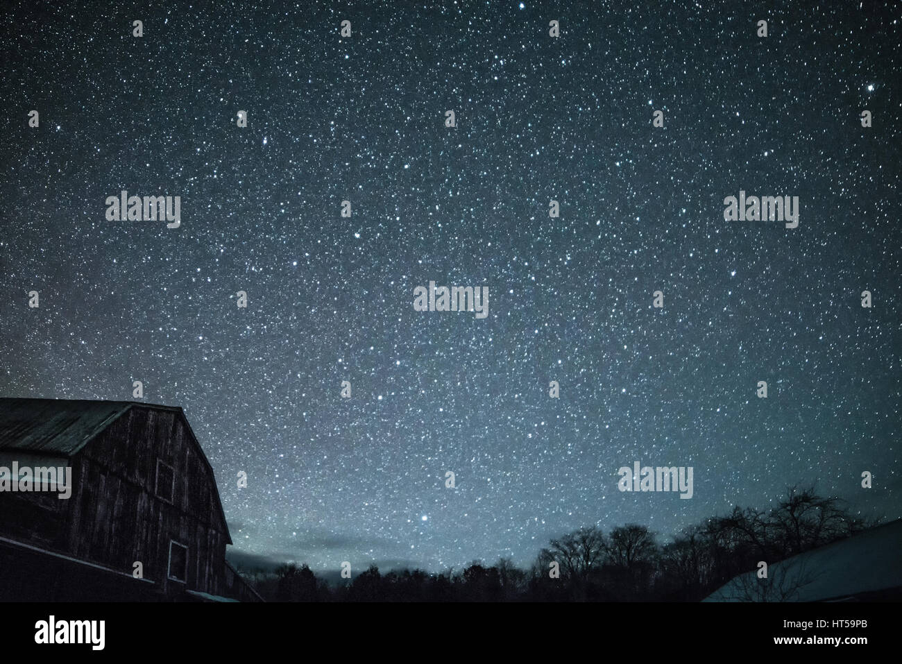 Rural Log Cabin barn at night with stars and milky way, and snow and ...