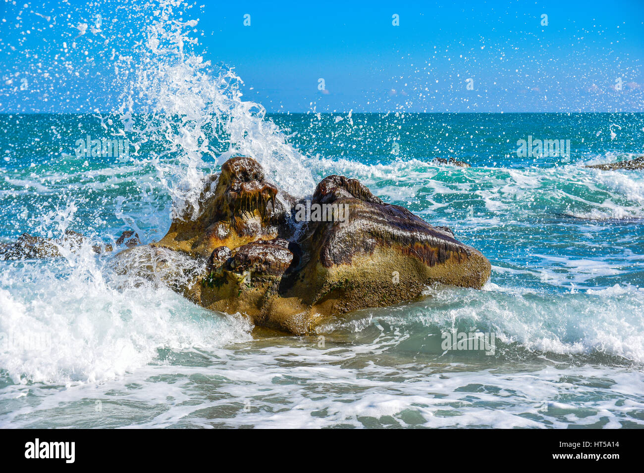 Large wave crash against the rocks at the beach Stock Photo - Alamy
