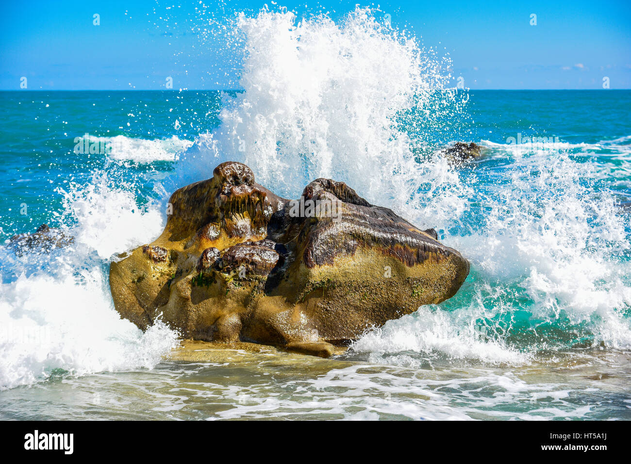 Large wave crash against the rocks at the beach Stock Photo - Alamy