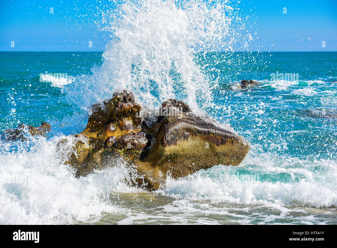Large wave crash against the rocks at the beach Stock Photo - Alamy