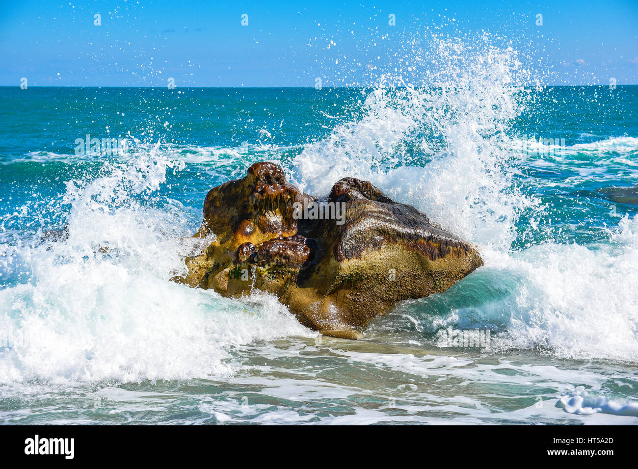 Large wave crash against the rocks at the beach Stock Photo - Alamy