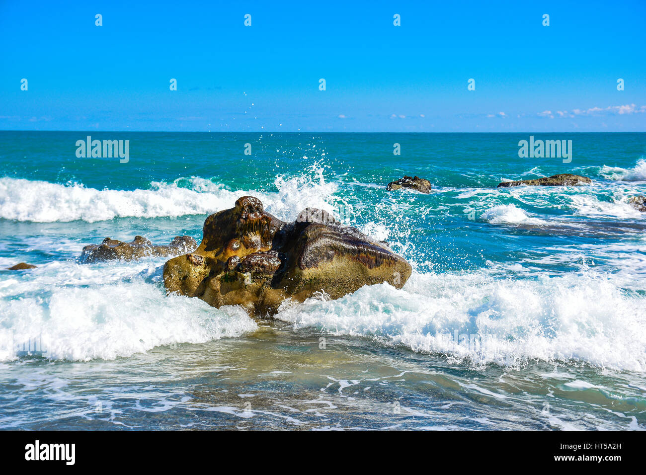 Large wave crash against the rocks at the beach Stock Photo - Alamy
