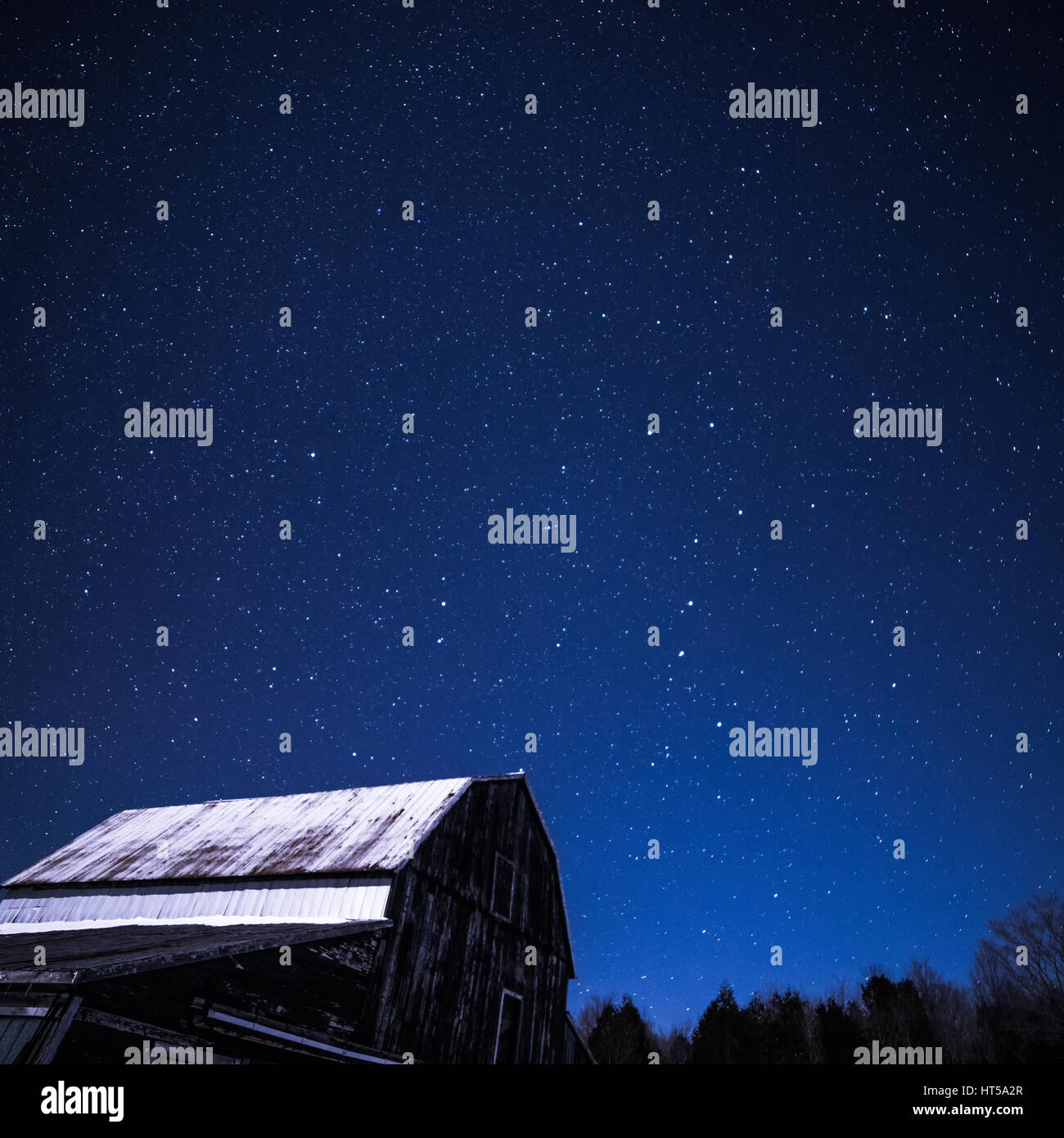 Rural Log Cabin barn at night with stars and milky way, and snow and ...