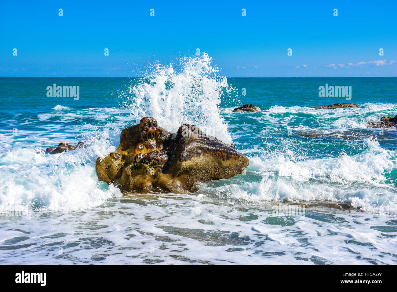 Large wave crash against the rocks at the beach Stock Photo - Alamy