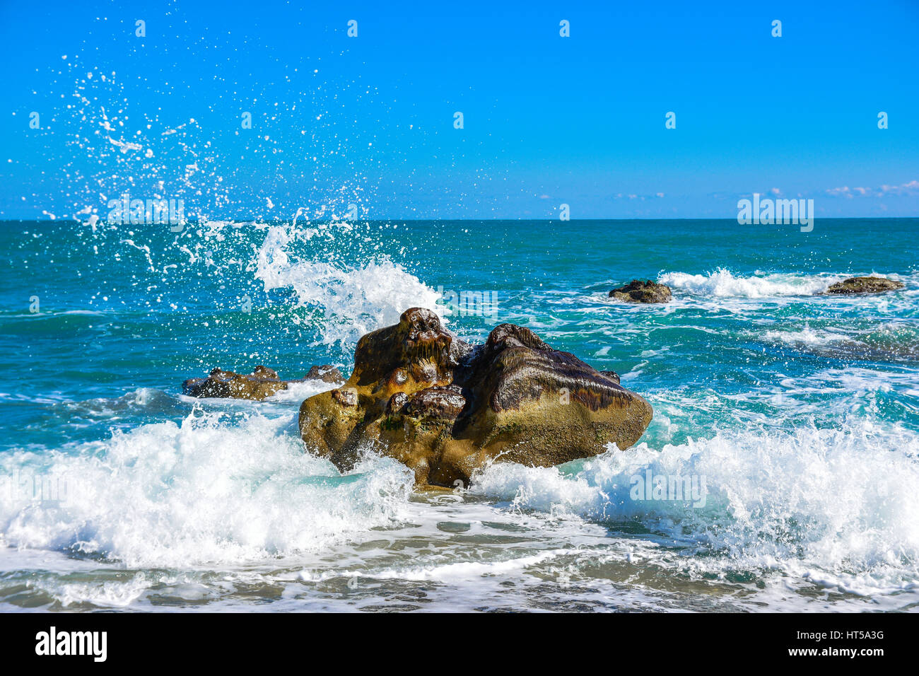 Large wave crash against the rocks at the beach Stock Photo - Alamy