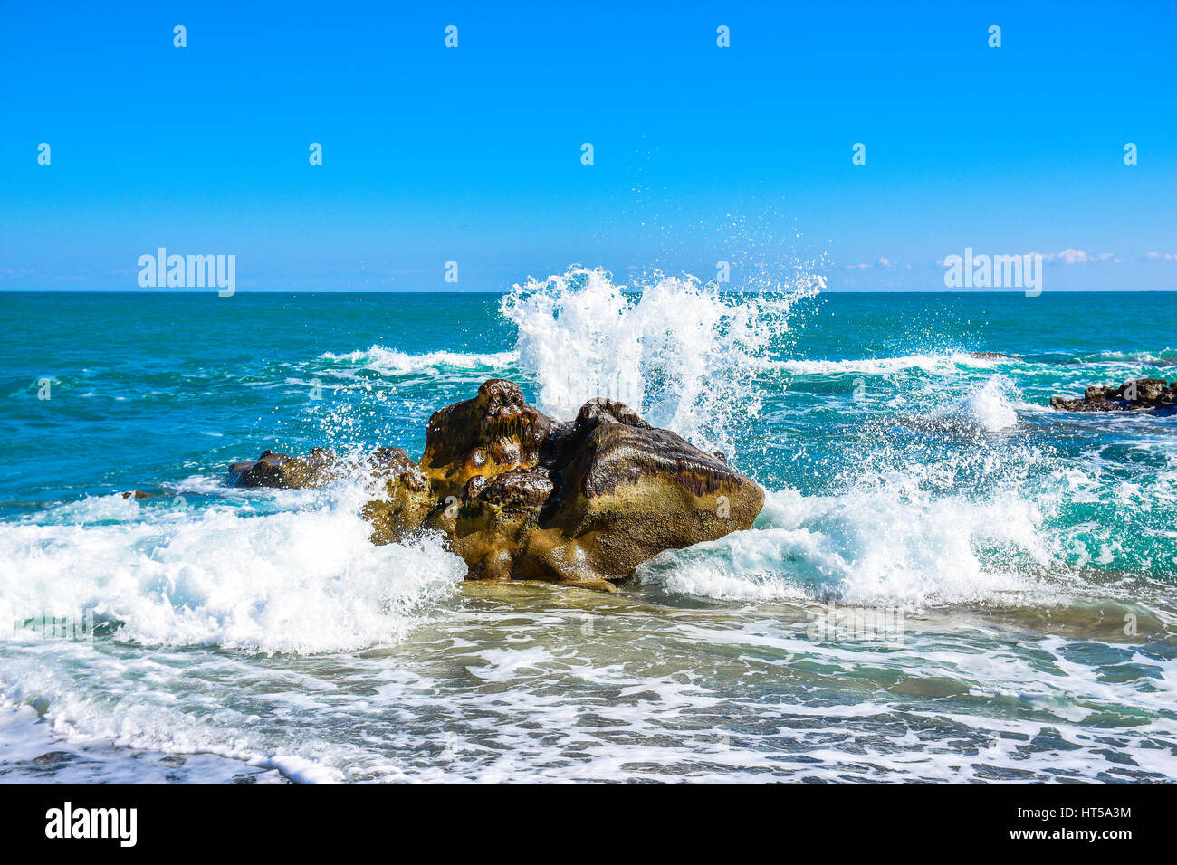 Large wave crash against the rocks at the beach Stock Photo - Alamy