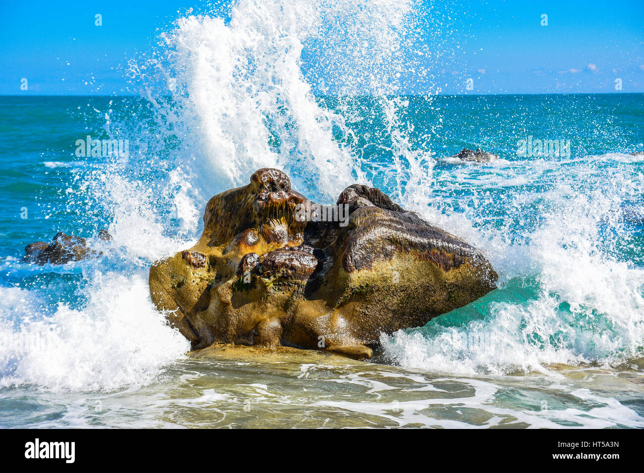 Large wave crash against the rocks at the beach Stock Photo - Alamy