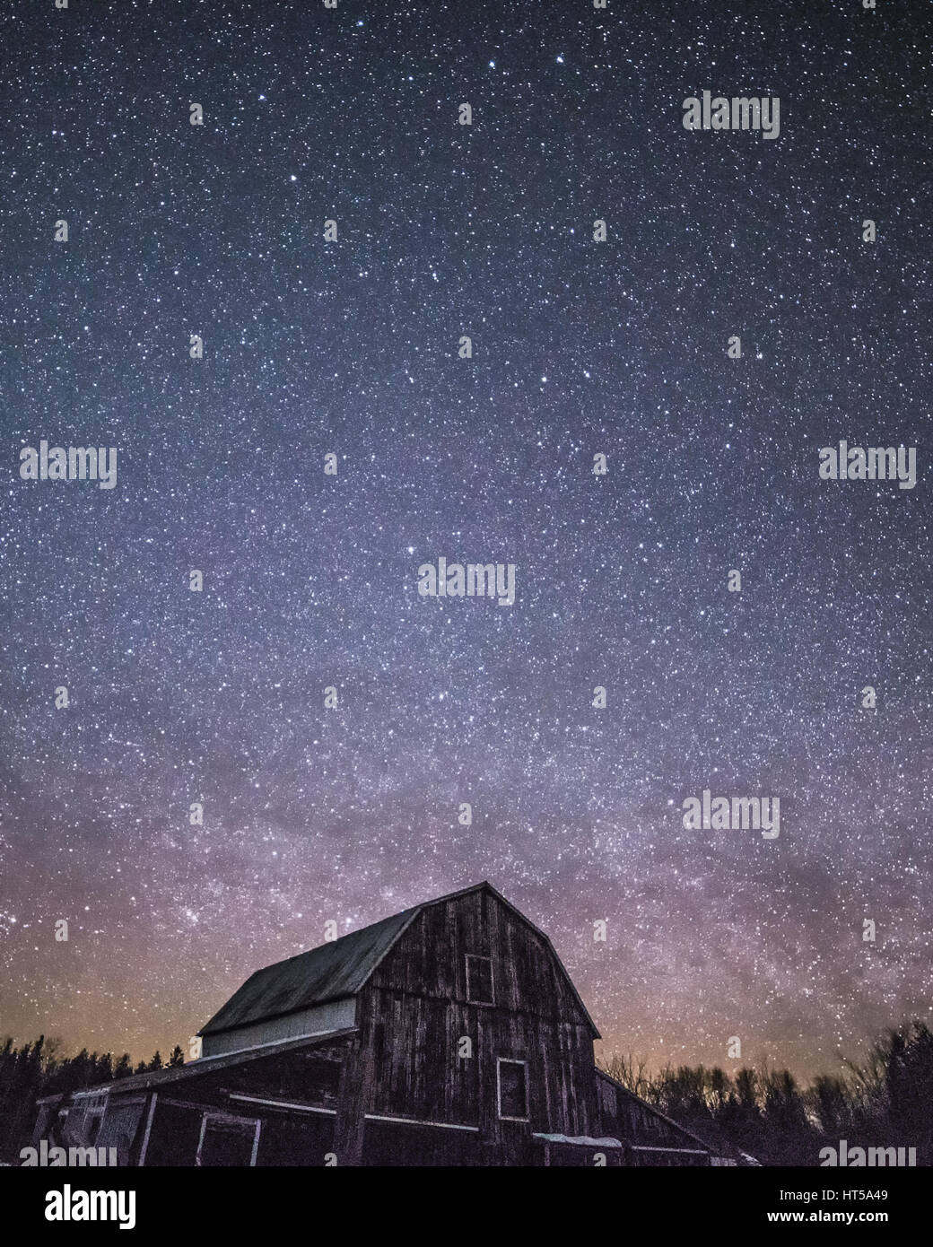 Rural Log Cabin barn at night with stars and milky way, and snow and ...