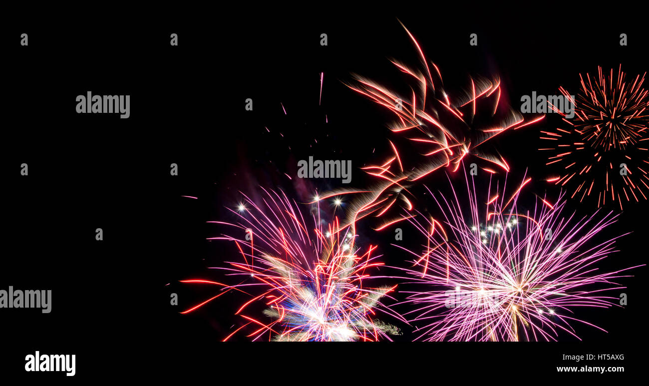 red and fuchsia fireworks on black background Stock Photo - Alamy