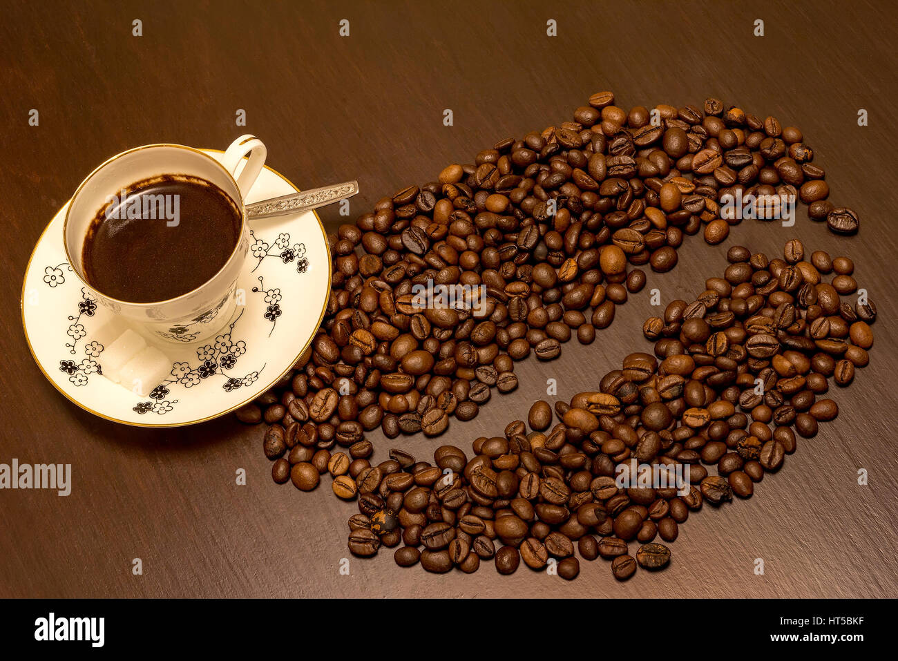 A cup of coffee and coffee beans like one big bean on the table Stock ...