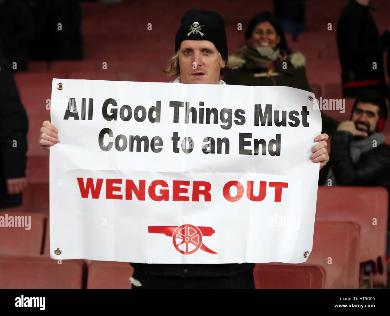 A fan with a 'Wenger Out' sign after the UEFA Champions League Round of ...