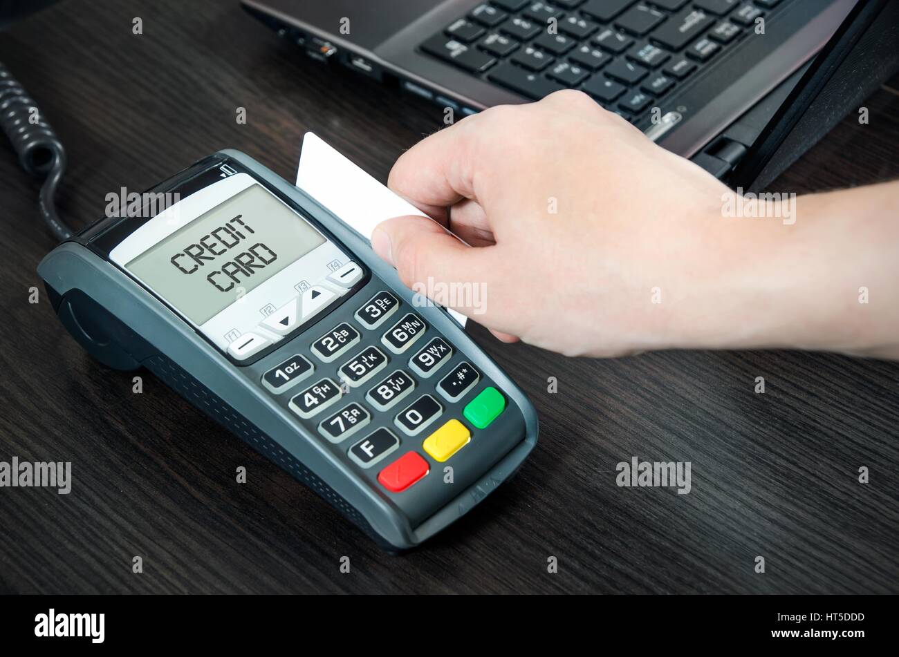 Man swiping credit card through credit hi-res stock photography and ...