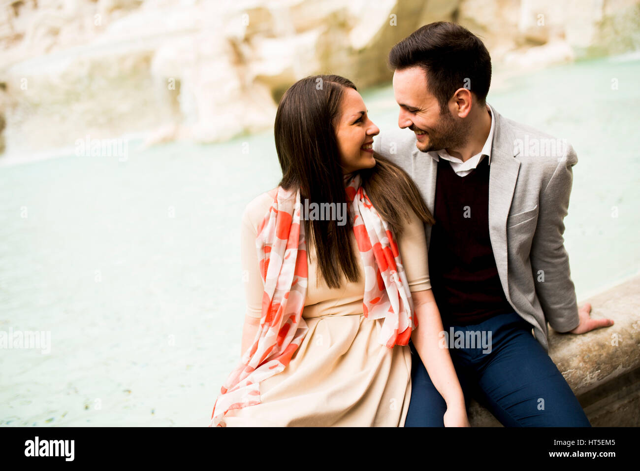 Tourist couple on travel by Trevi Fountain in Rome, Italy Stock Photo ...