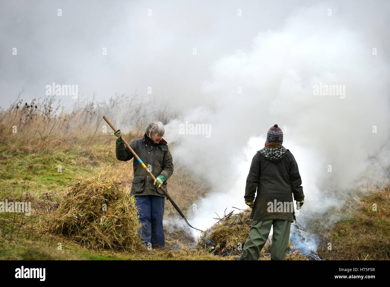 Volunteers help clear rubbish and brambles from a SSSI at the base of ...