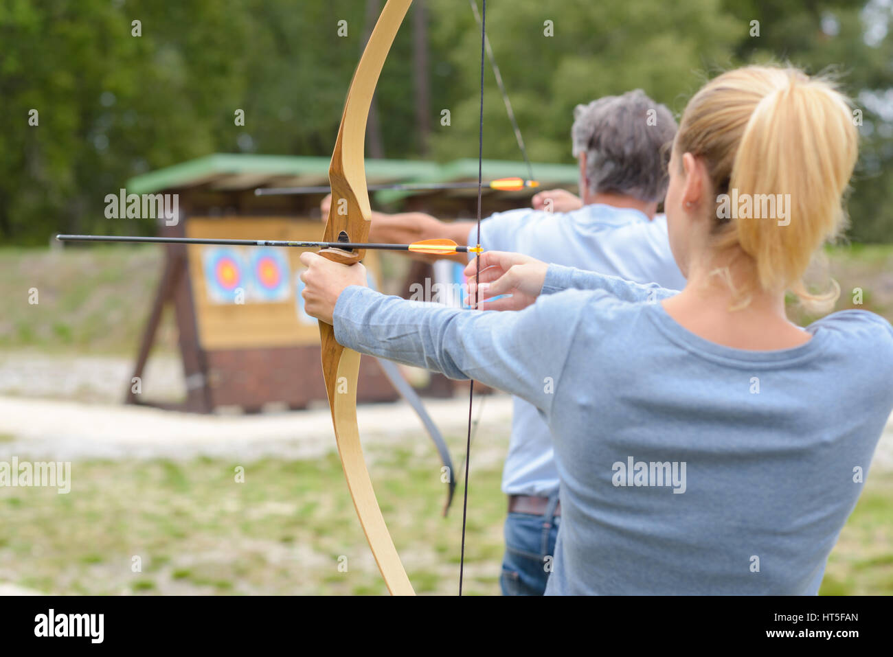 Couple during archery practice Stock Photo - Alamy