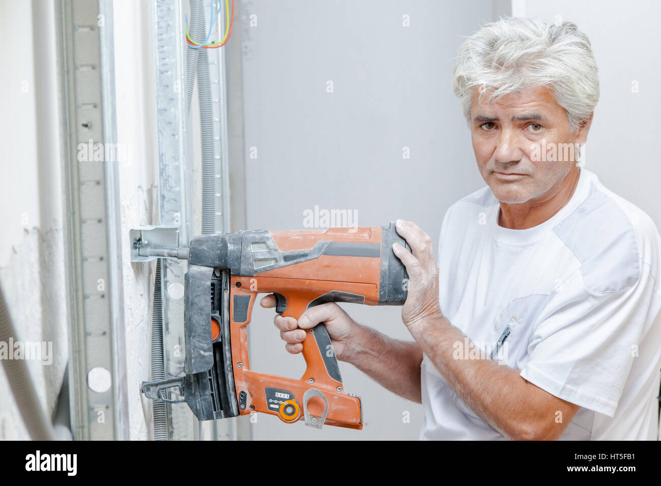 Using a stud gun Stock Photo - Alamy