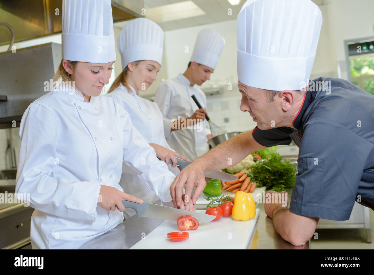 Chef guiding trainee Stock Photo - Alamy