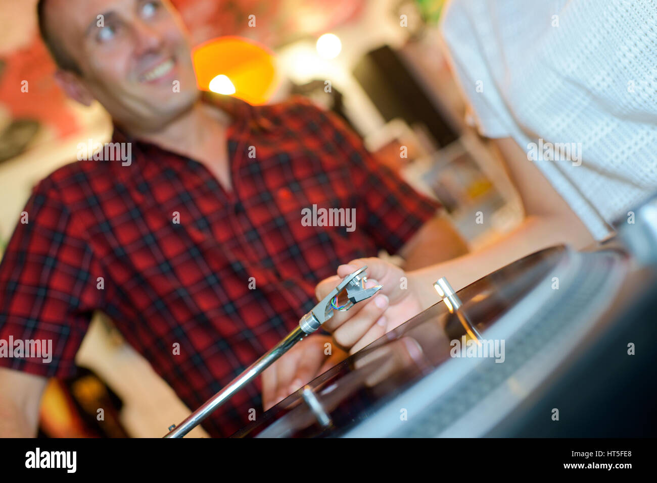 People playing a vinyl record Stock Photo - Alamy