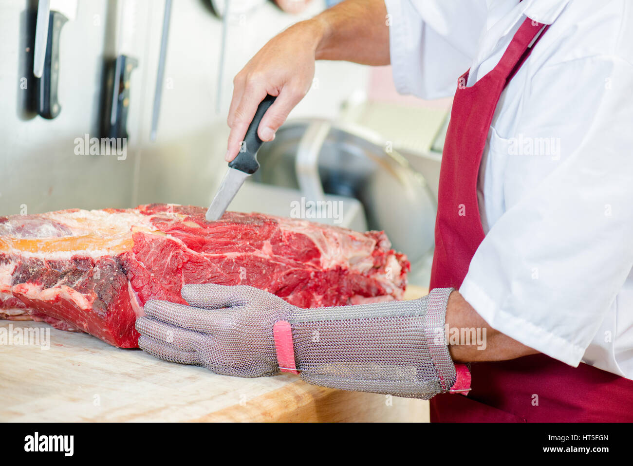 Butcher cutting meat Stock Photo - Alamy