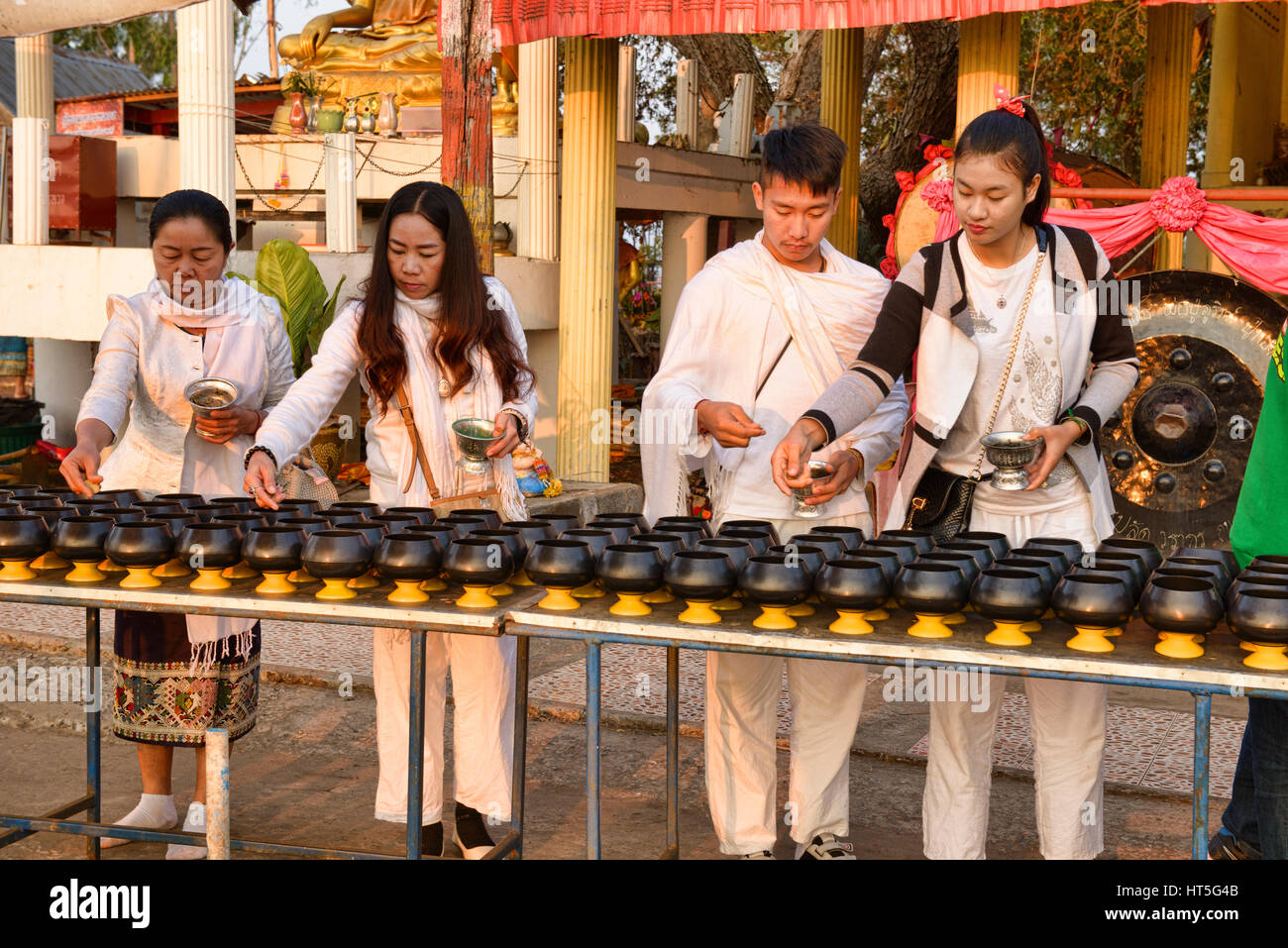 Making merit at a temple on Talay Bua Daeng, the red lotus lake outside ...