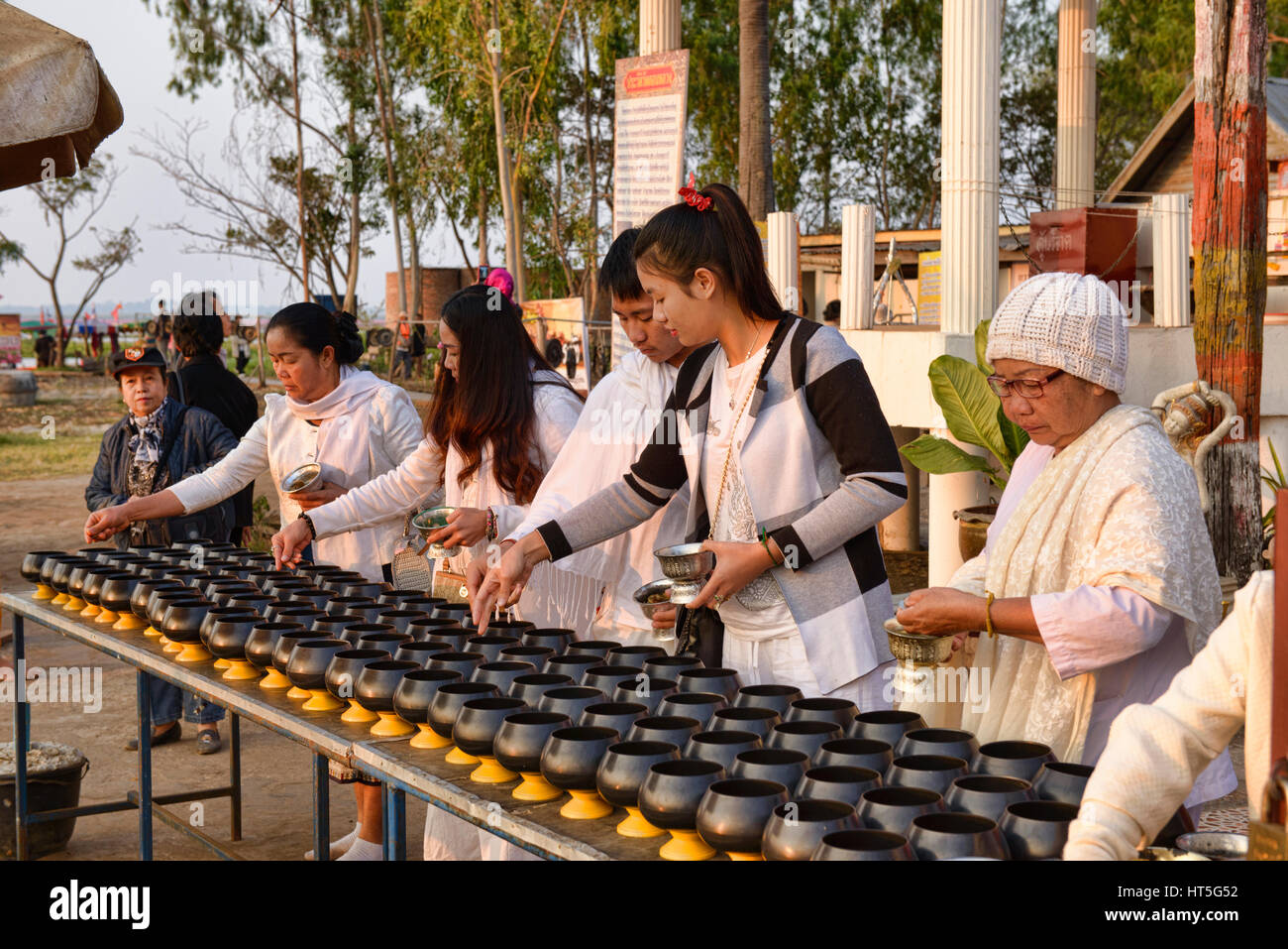 Making merit at a temple on Talay Bua Daeng, the red lotus lake outside ...