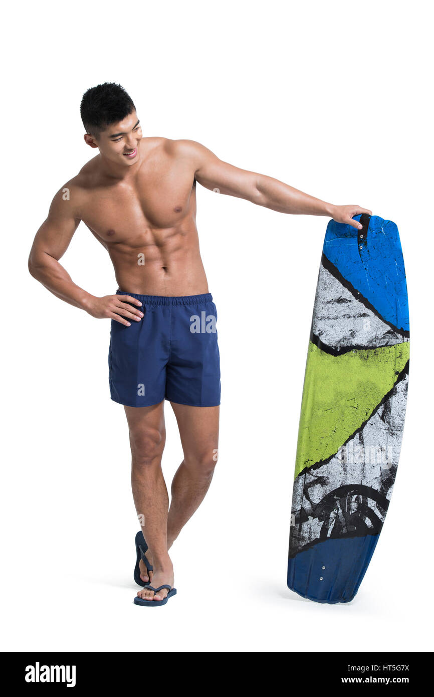 Young muscular man with surfboard Stock Photo - Alamy