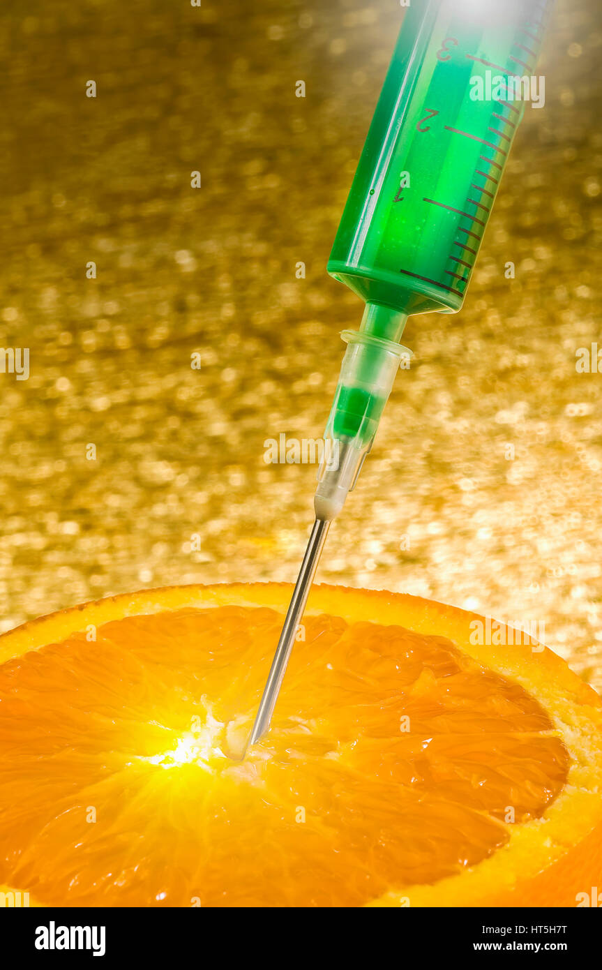 shinny close-up photo of syringe full of green liquid with needle ...