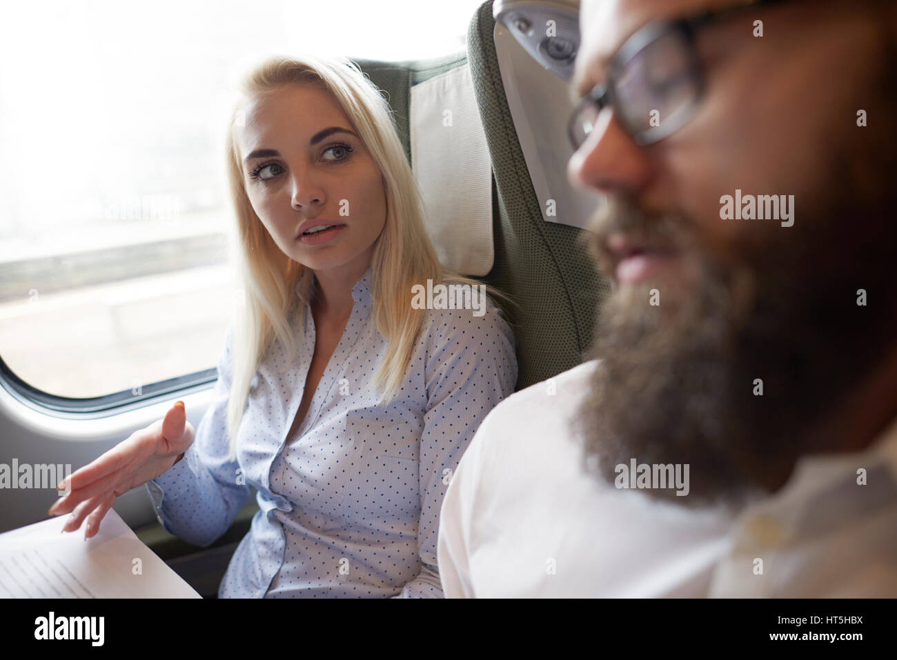 Serious conversation while journey by train Stock Photo - Alamy